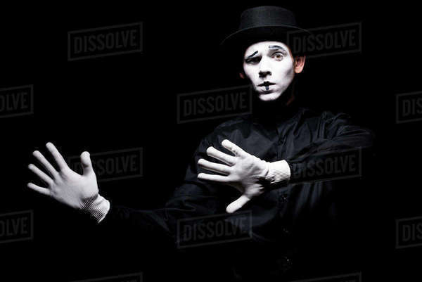 Mime pretending touching something isolated on black - Royalty-free ...
