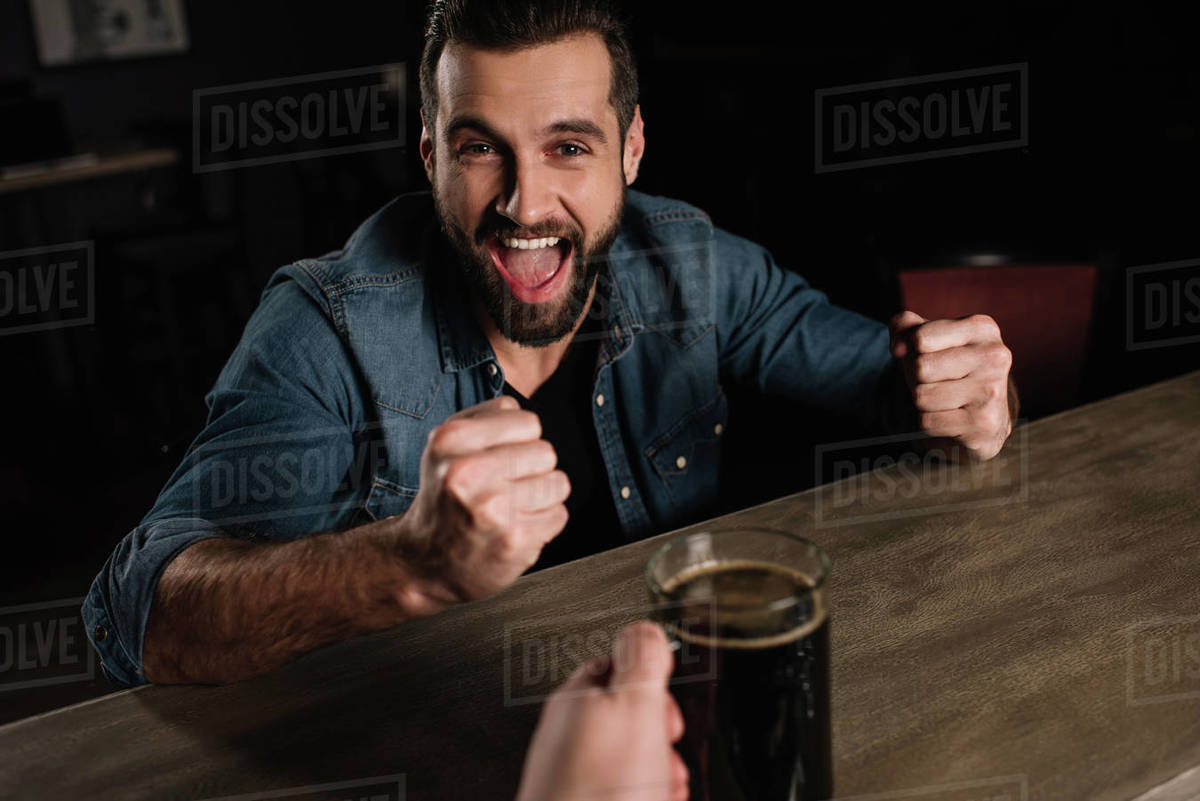 Bartender giving beer to visitor and he showing yes gesture - Royalty ...