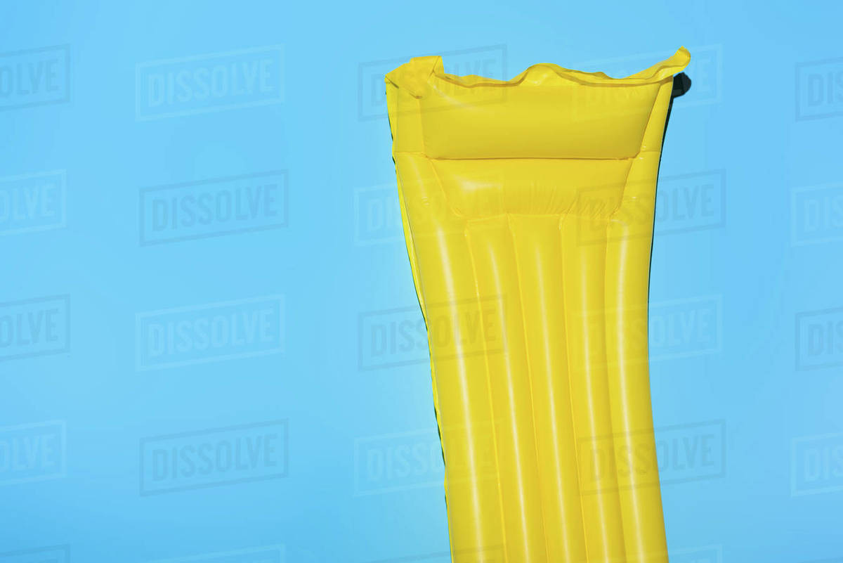 Yellow inflatable mattress on blue with copy space - Royalty-free Stock ...