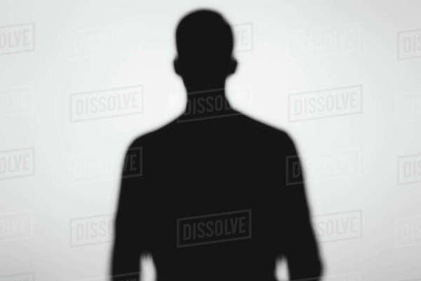 Mysterious blurry shadow of spooky person standing on grey - Royalty ...