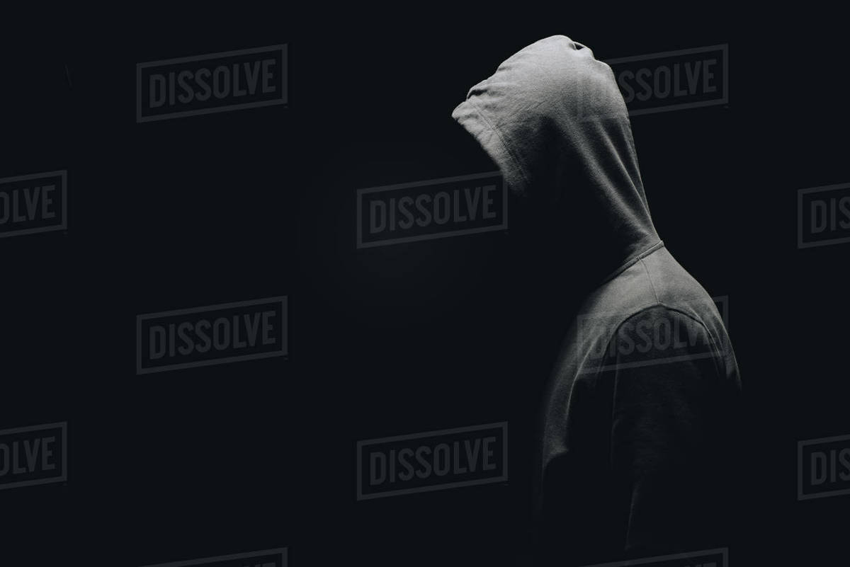 side view of unrecognizable man in man standing isolated on black ...