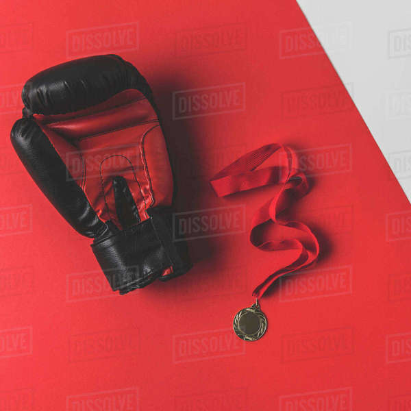 top view of boxing glove with medal on red surface - Royalty-free Stock ...
