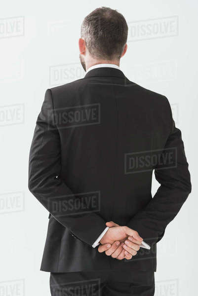back view of businessman in black suit holding hands on back isolated ...