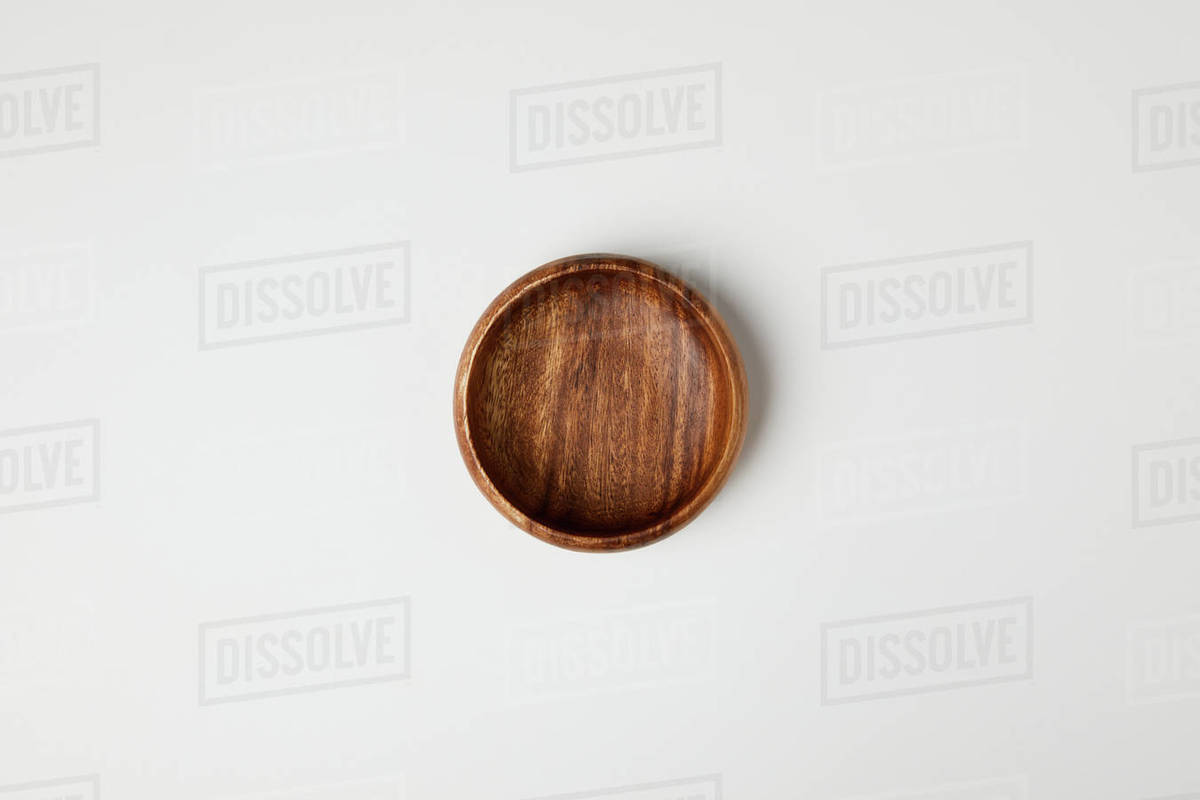 Top view of wooden bowl isolated on white - Stock Photo - Dissolve
