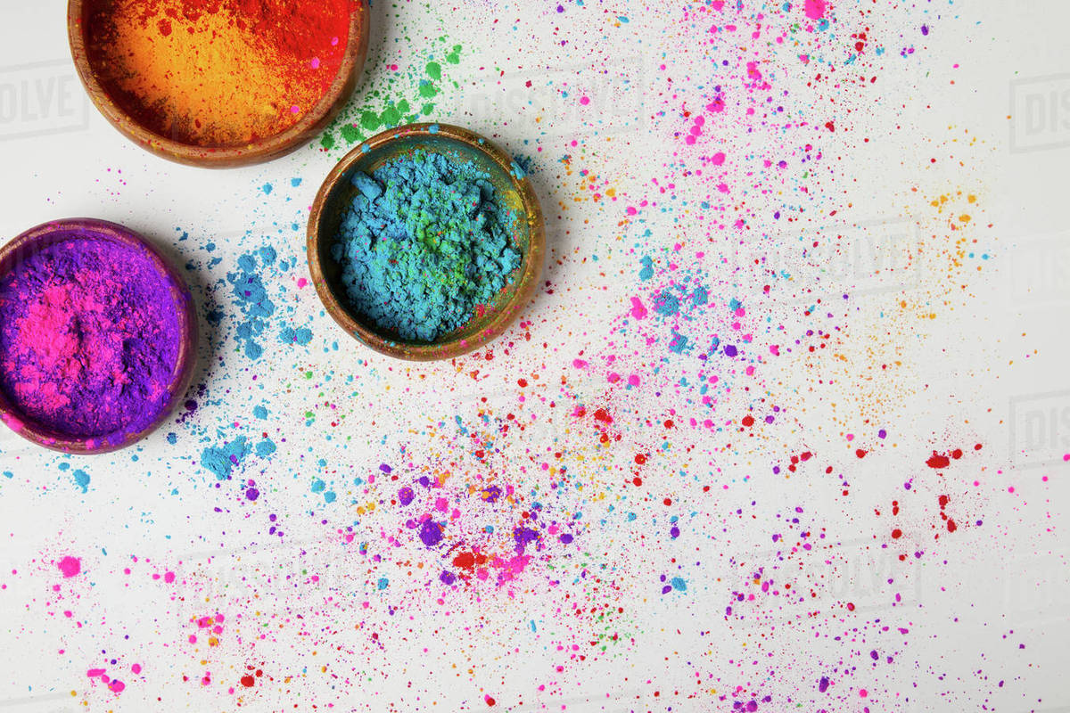 Top view of traditional holi paint in bowls isolated on white, Hindu ...