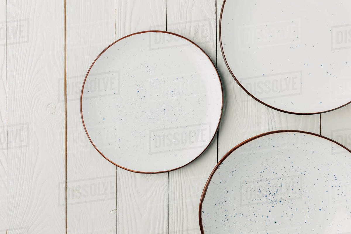 Ceramic glazed plates on white wooden background - Royalty-free Stock ...