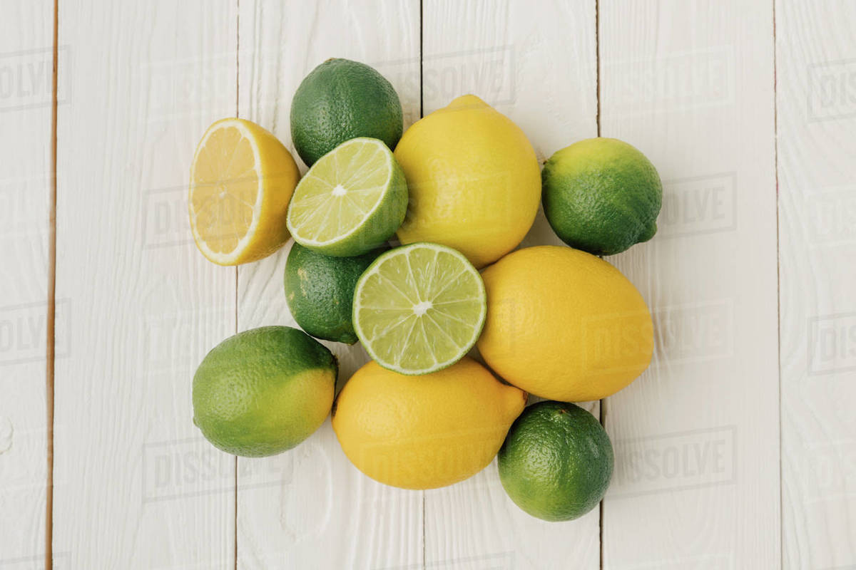 Top view of citrus fruits on white wooden background - Stock Photo ...