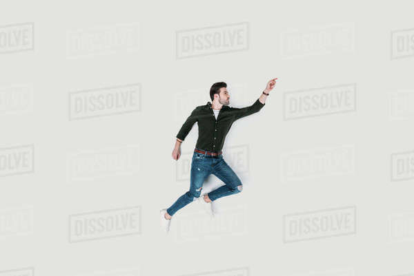 Top view of handsome young man jumping isolated on white - Stock Photo ...