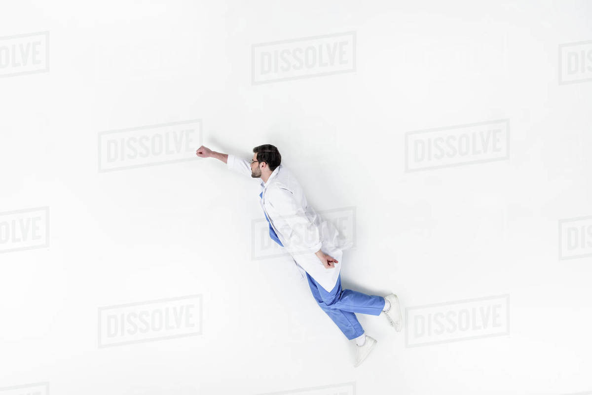 Top view of doctor flying like super hero isolated on white - Royalty ...