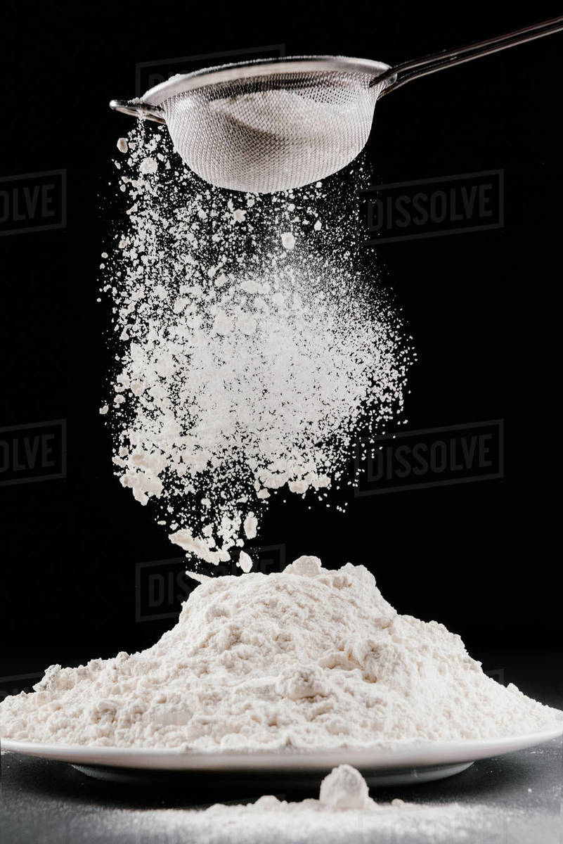 Flour falling from sieve on pile isolated on black - Royalty-free Stock ...