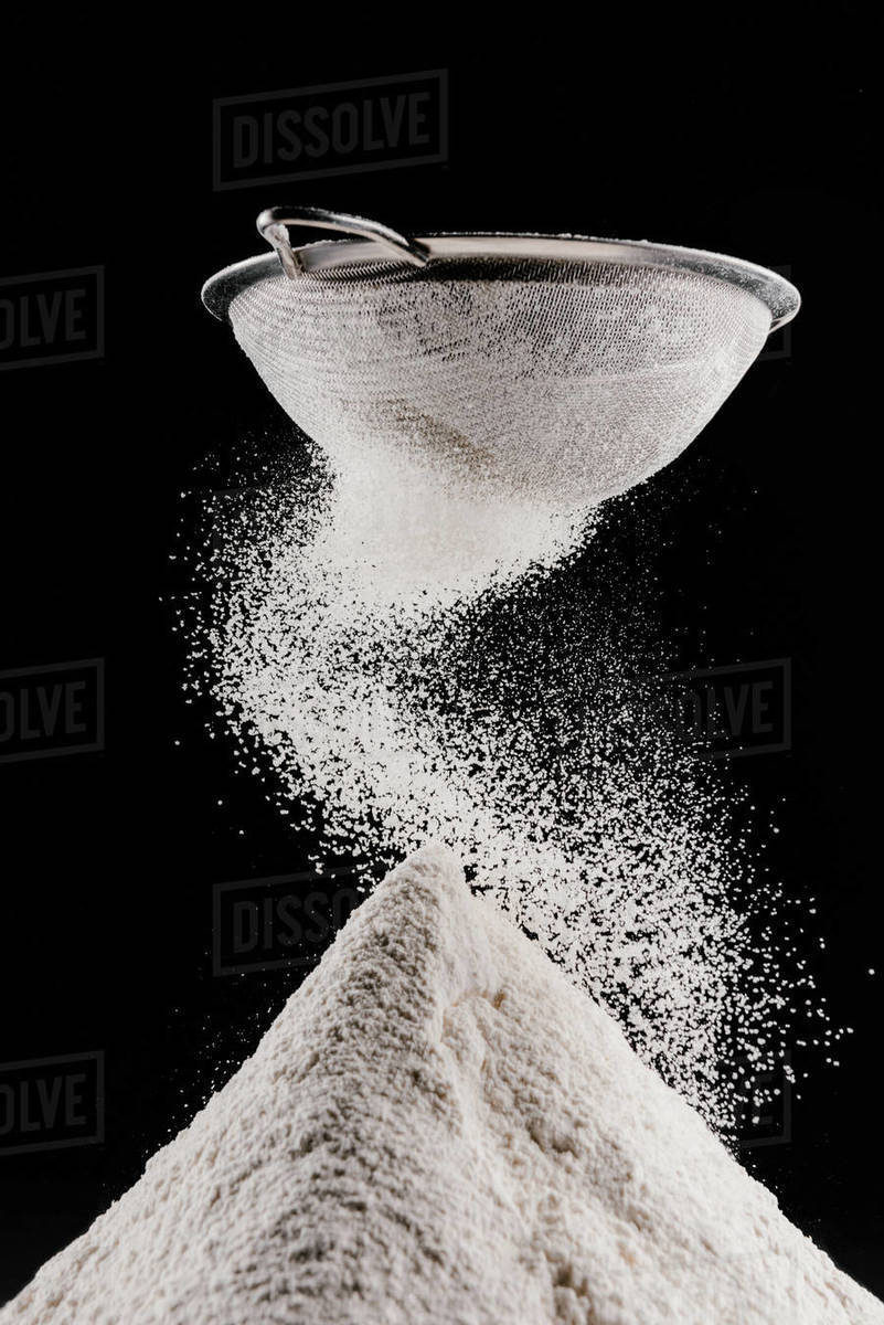 Flour falling after sieving on pile isolated on black - Royalty-free ...