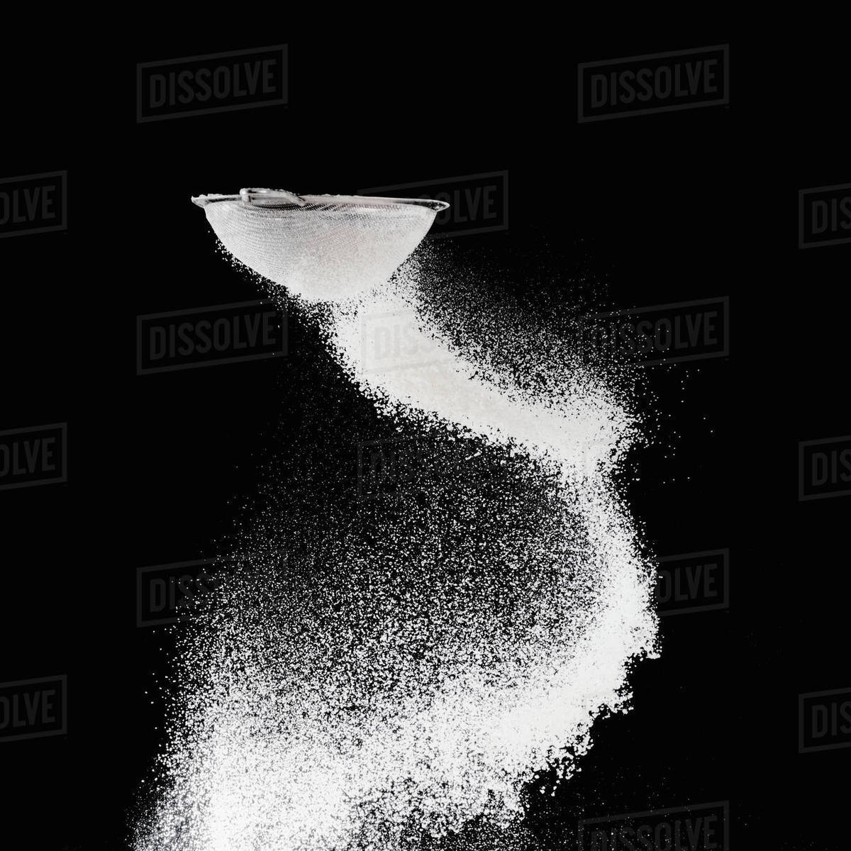 Sieve with falling flour isolated on black - Royalty-free Stock Photo | Dissolve