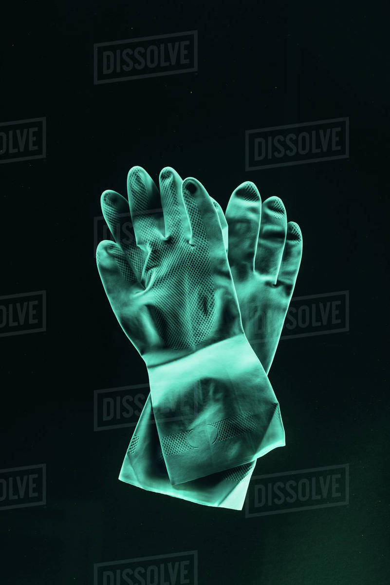 Top view of protective rubber turquoise gloves isolated on black ...