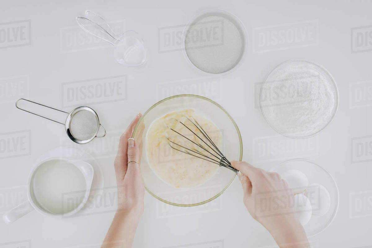 Partial top view of person cooking pancakes isolated on grey - Royalty ...