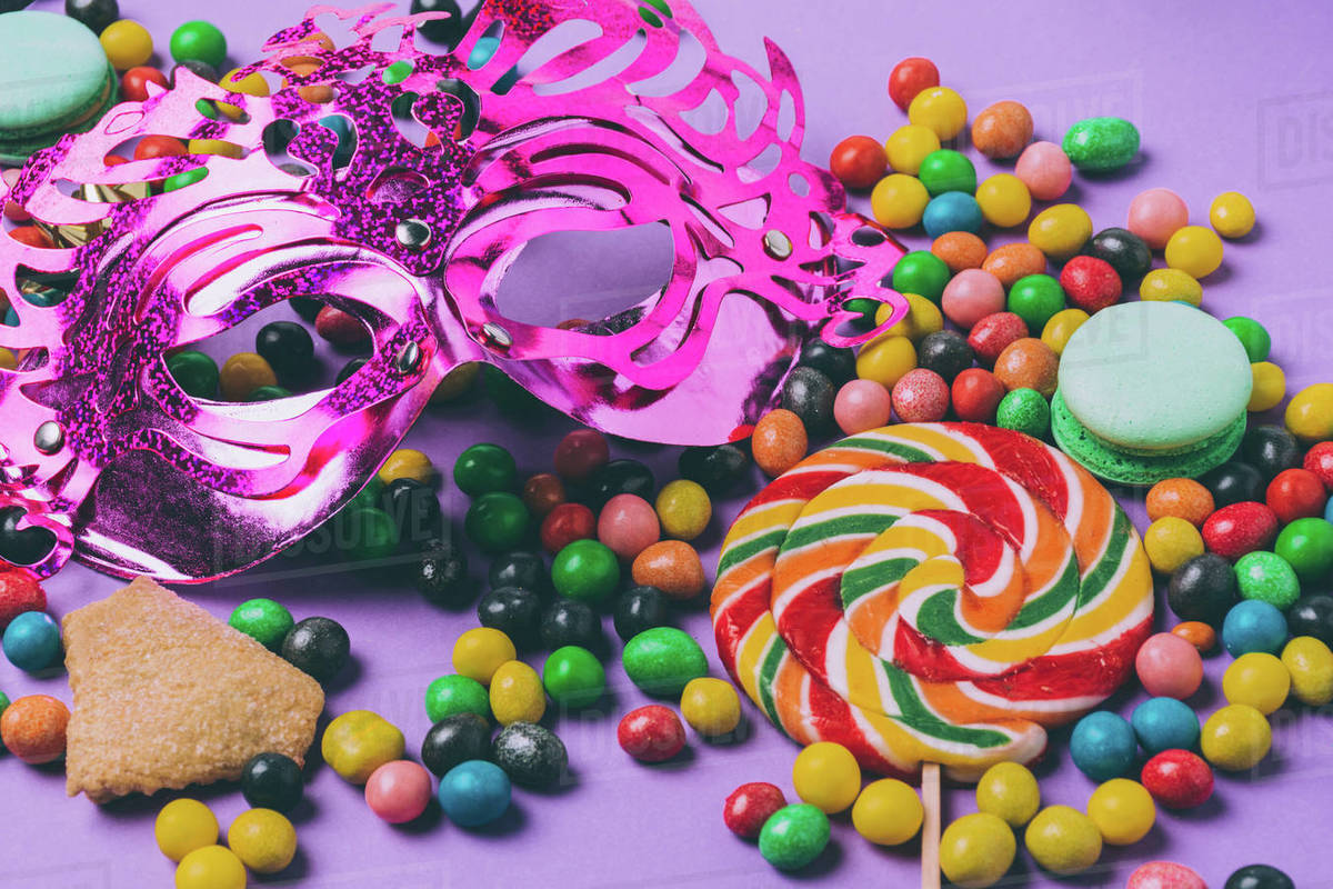 Close up view of masquerade mask, lollipop and candies isolated on ...