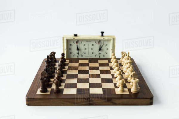 Chess clock and board with chess pieces isolated on white - Royalty ...