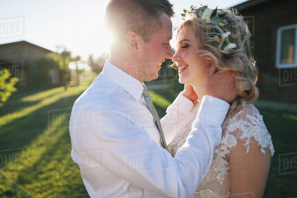 beautiful happy young wedding couple smiling each other outdoors ...