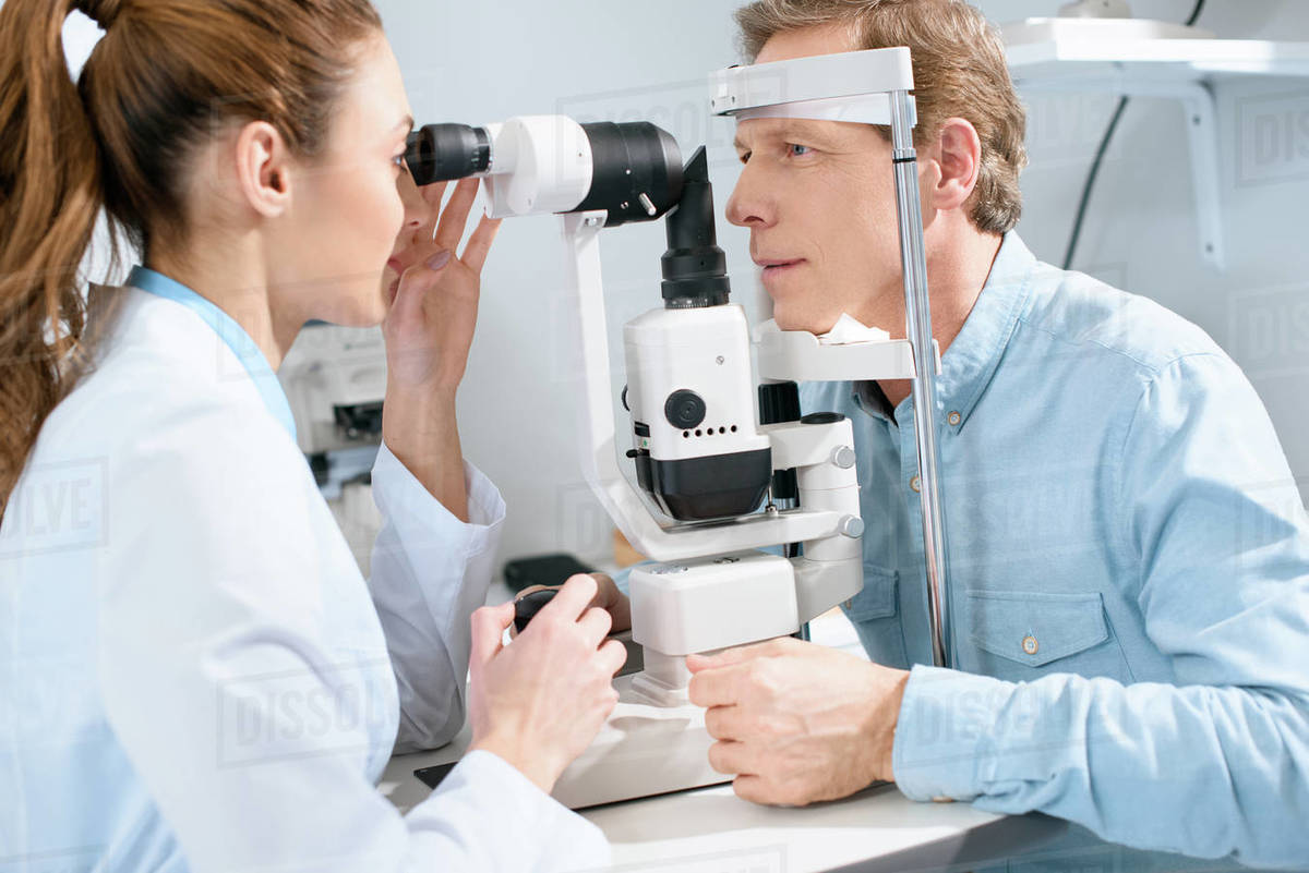 Professional oculist examining man with visual field test - Royalty ...