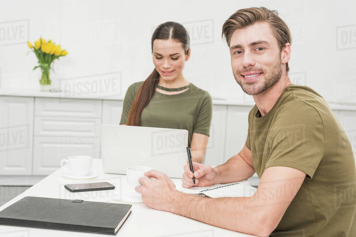 Young happy couple working together on kitchen at home - Royalty-free ...