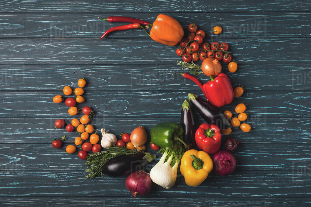 Top view of round of ripe organic vegetables on wooden table - Royalty ...
