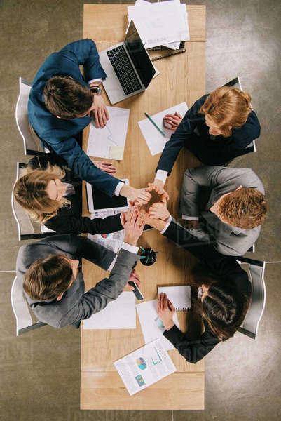 Overhead view of business partners at table in office, businesspeople ...