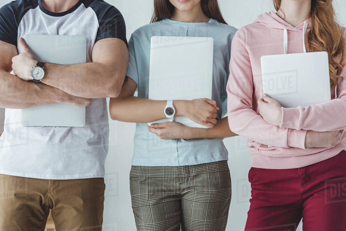 Cropped view of young students holding laptops - Royalty-free Stock ...