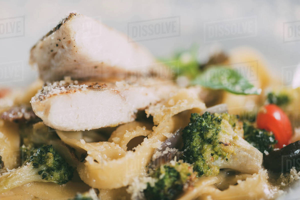 Close-up view of gourmet pasta with pike perch fillet, vegetables and ...