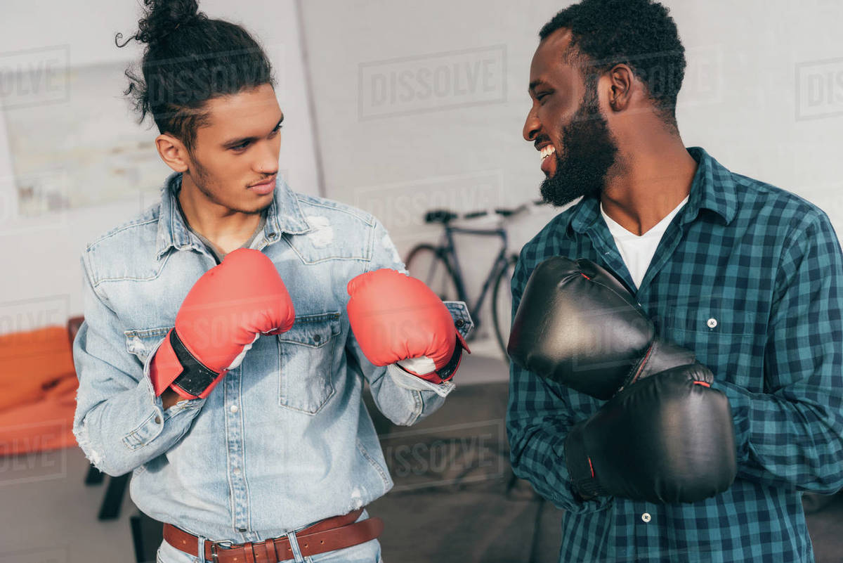 Young multicultural male friends boxing in gloves - Royalty-free Stock ...