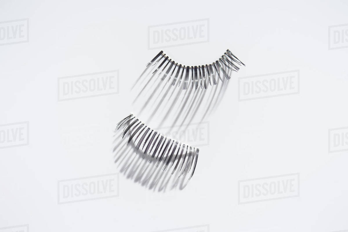 Set of long fake eyelashes on white background - Stock Photo - Dissolve