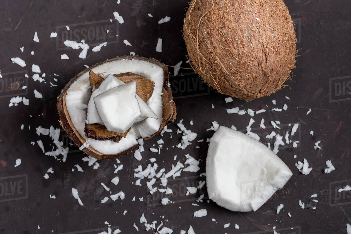 Top view of pieces of ripe tropical coconut on dark background, coconut ...