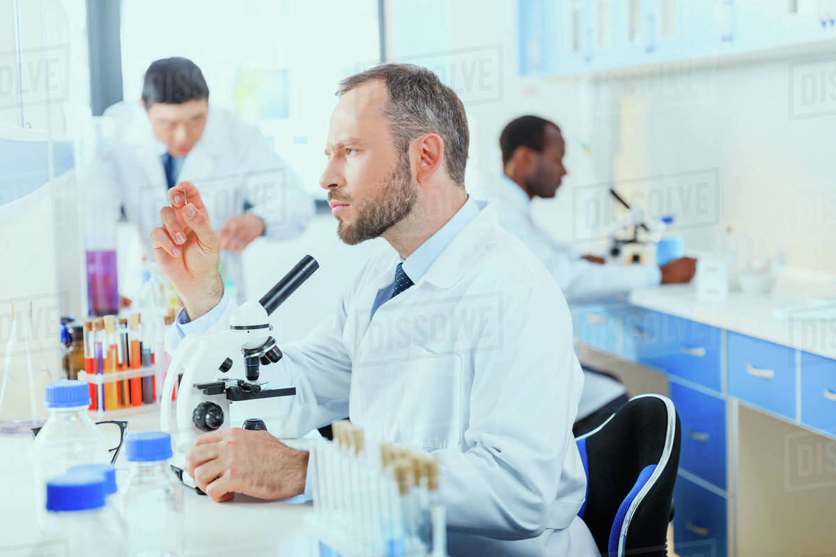 Young doctors in uniform working at testing laboratory, laboratory ...