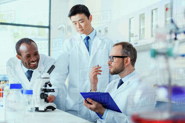 Young doctors in uniform working at testing laboratory, laboratory ...