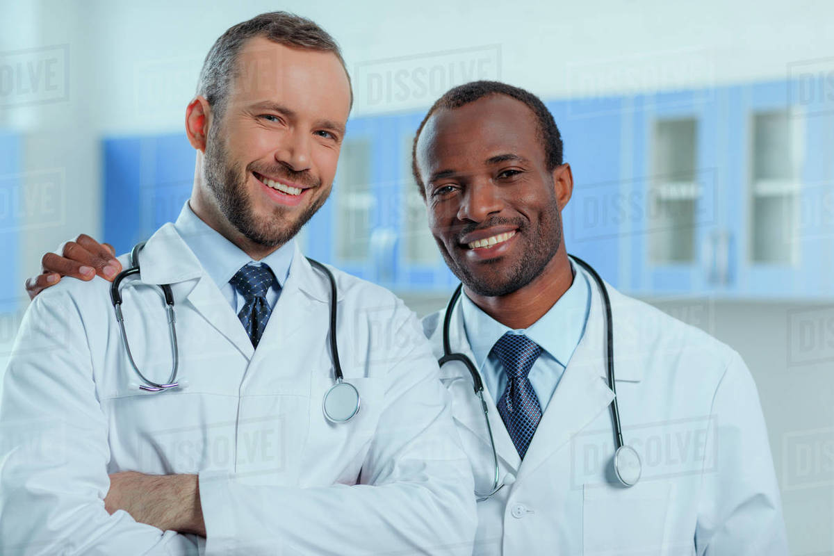 Portrait of multiracial group of doctors in medical uniforms in clinic ...