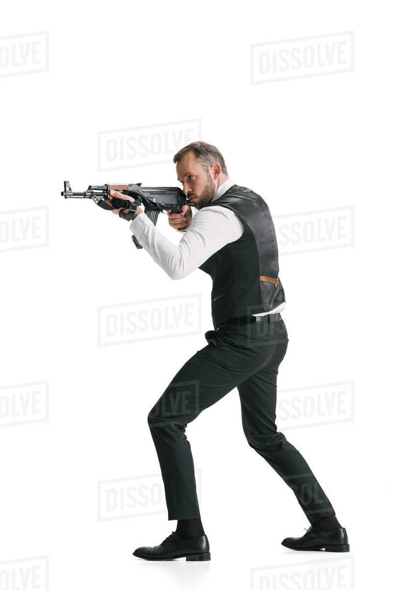 Secret agent in suit aiming with rifle isolated on white - Royalty-free ...