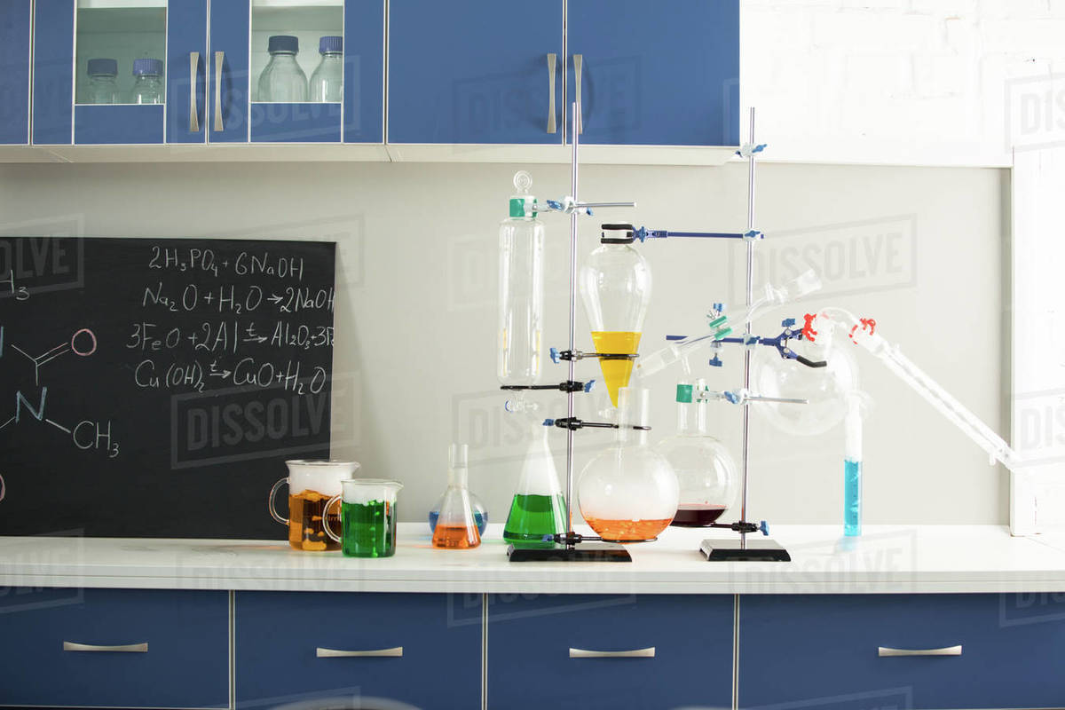 Science laboratory interior with colorful reagents and blackboard ...