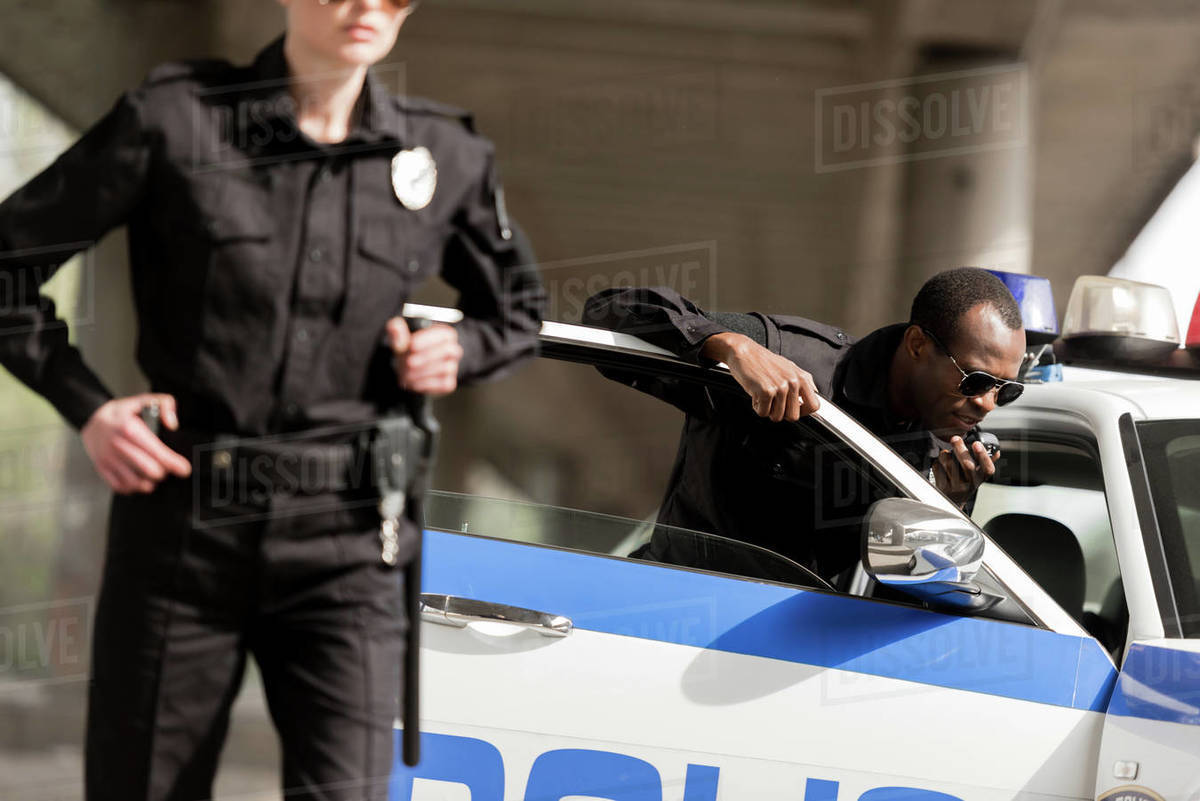 Young police officers standing near car - Royalty-free Stock Photo ...