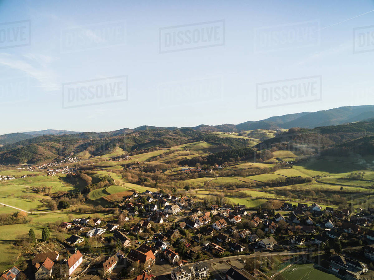 Aerial view of buildings and beautiful landscape with green hills ...