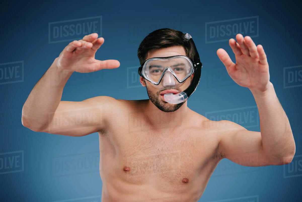 Handsome shirtless young man in snorkel and diving mask swimming and ...