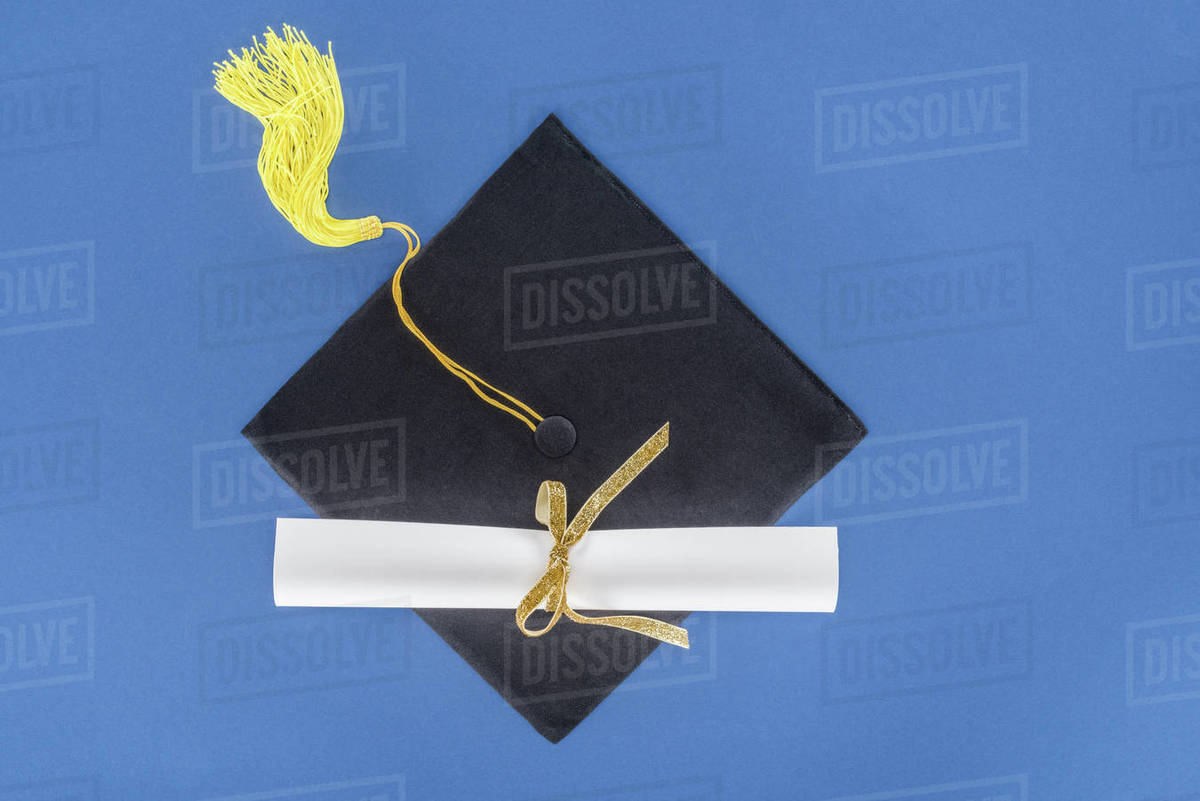 Graduation concept with diploma and graduation cap isolated on blue ...