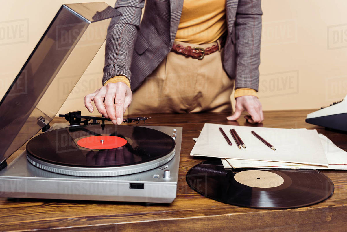Cropped image of woman turning on vinyl record player - Stock Photo ...