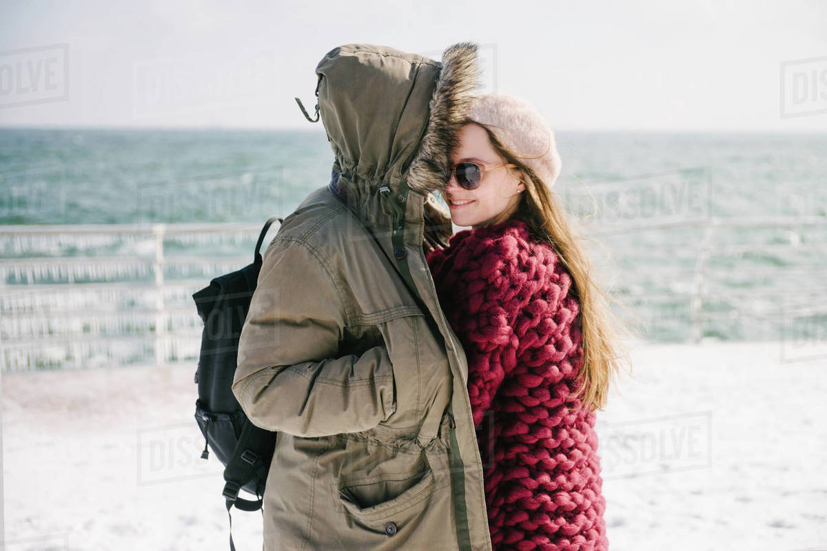 Young couple hugging on quay at winter - Stock Photo - Dissolve
