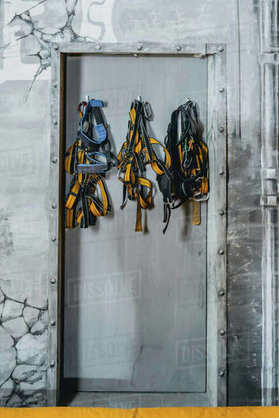 Climbing harnesses hanging on the wall at the gym - Royalty-free Stock ...