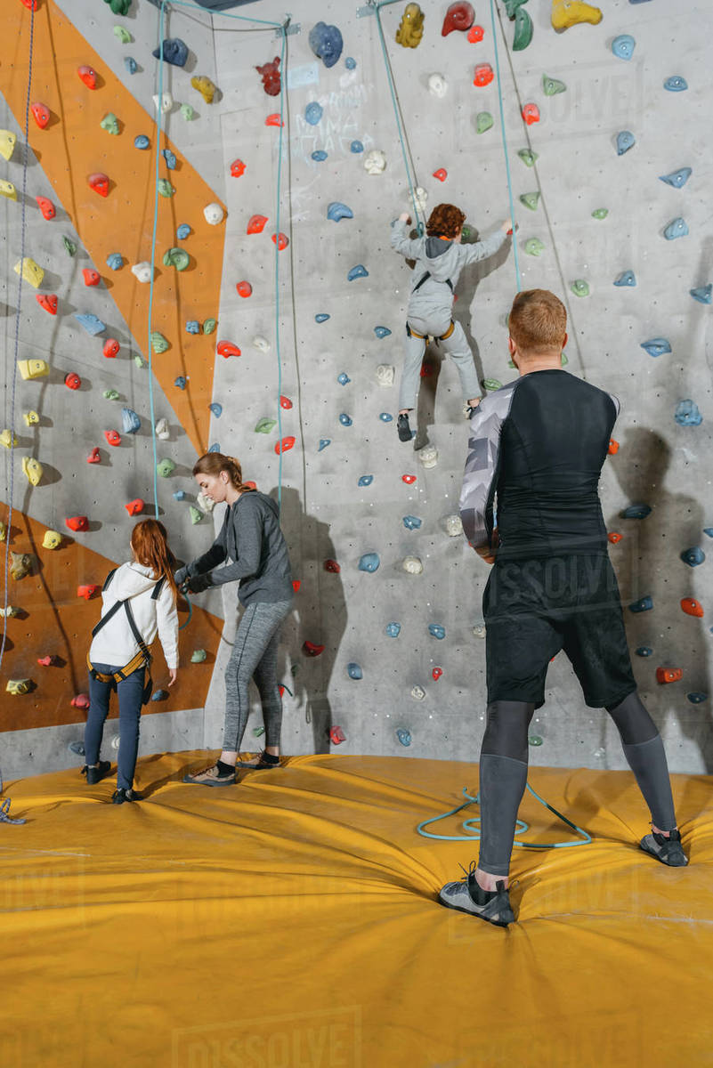 Full-length shot of family with children training in climbing walls ...