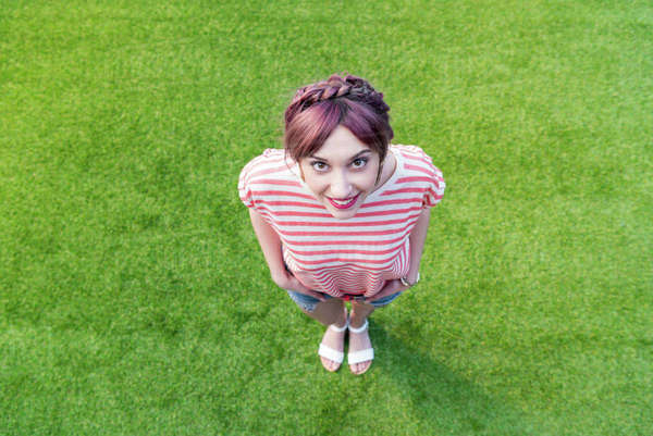 high angle view of beautiful happy girl smiling at camera while ...