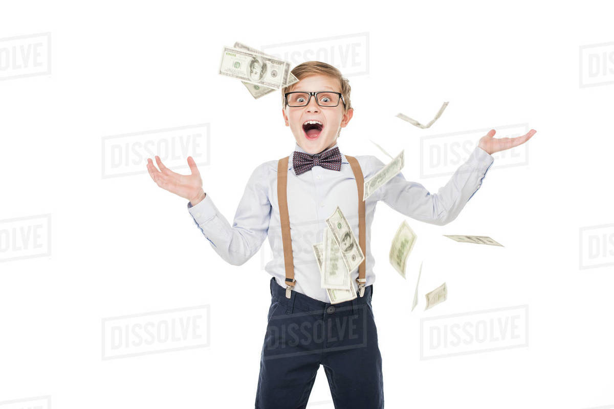 Excited little boy throwing dollar banknotes isolated on white ...
