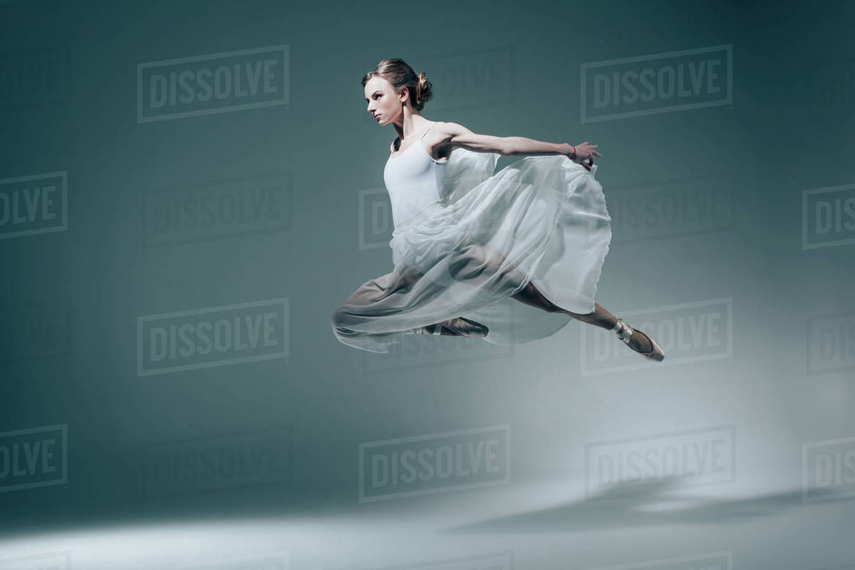 Attractive ballet dancer jumping in white dress - Royalty-free Stock ...
