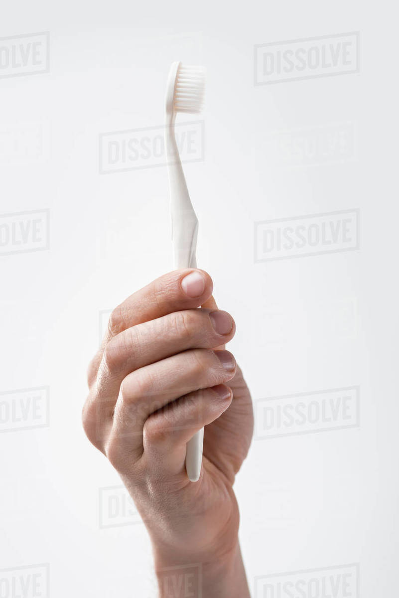 Cropped view of man holding toothbrush, isolated on white - Royalty ...