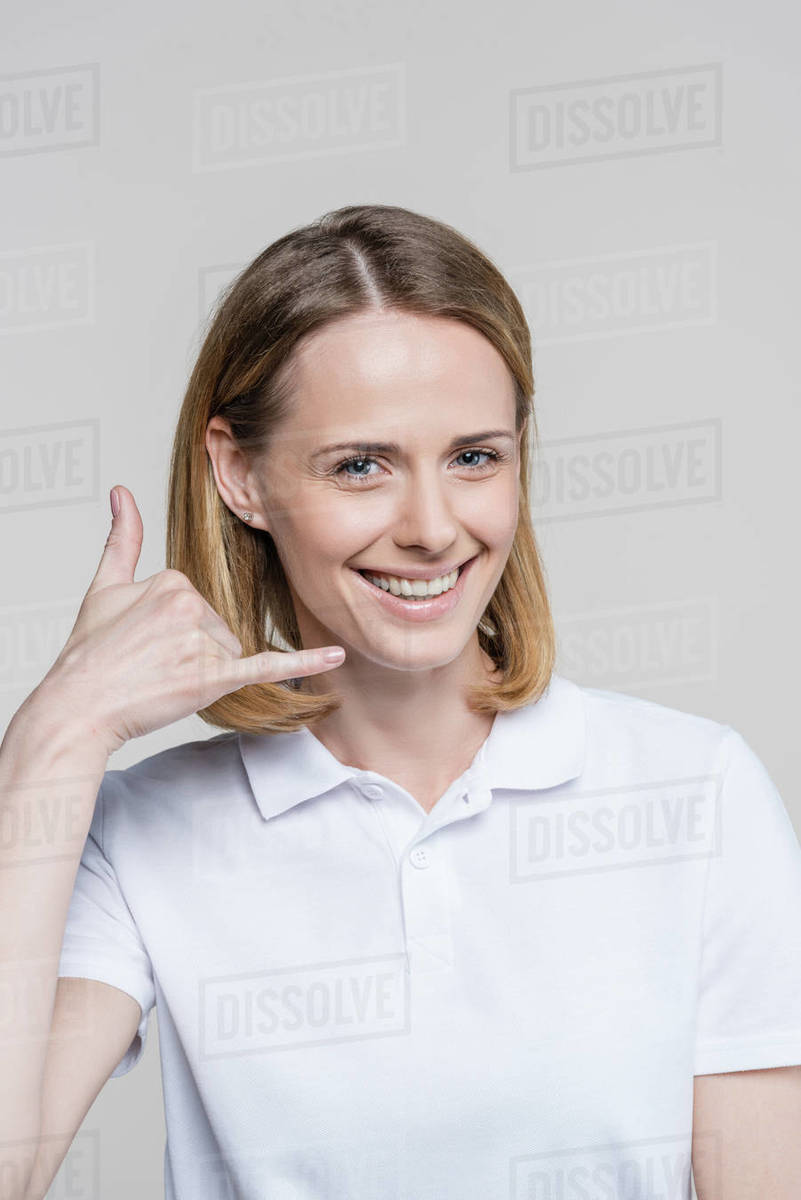 Portrait of attractive cheerful woman with call me symbol, isolated on ...