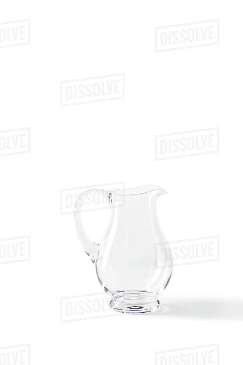 One empty glass jug isolated on white with copy space - Royalty-free ...
