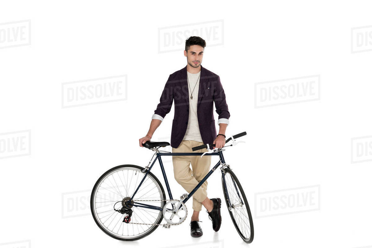 Full length view of handsome stylish young man standing with bicycle ...